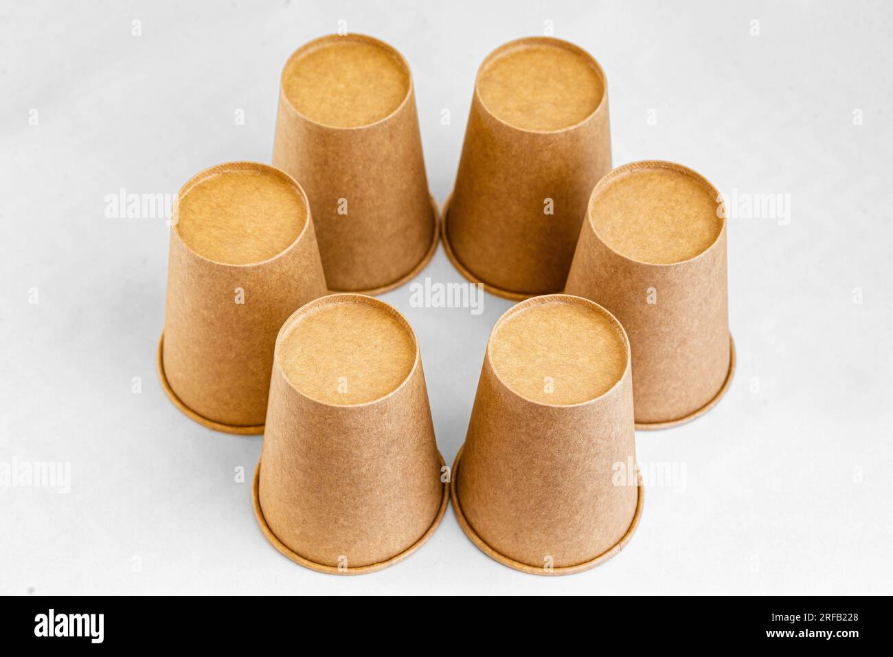 Stack of paper mugs. Six disposable paper cups made of cardboard kraft ...