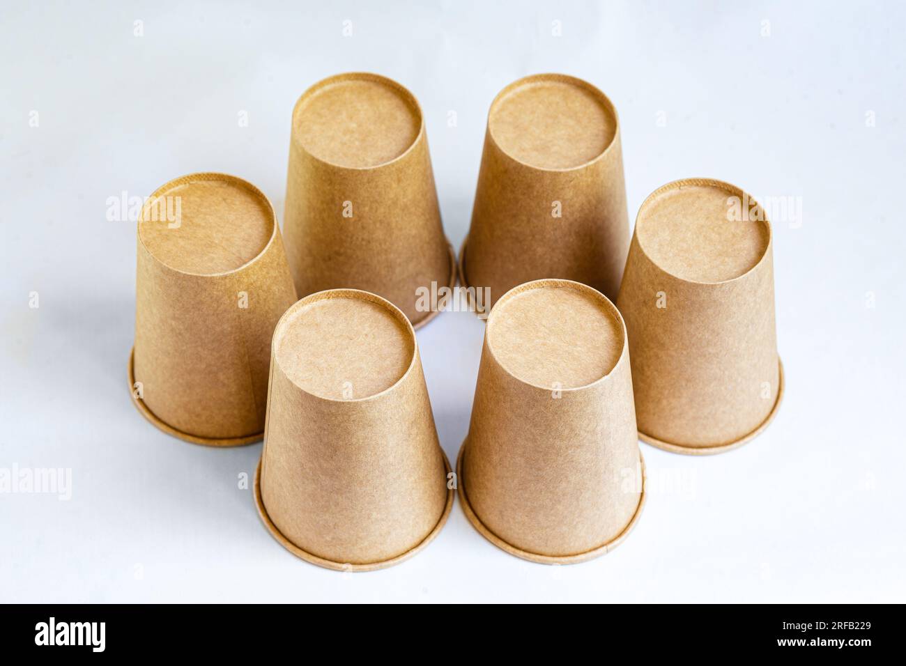 Stack of paper mugs. Six disposable paper cups made of cardboard kraft ...