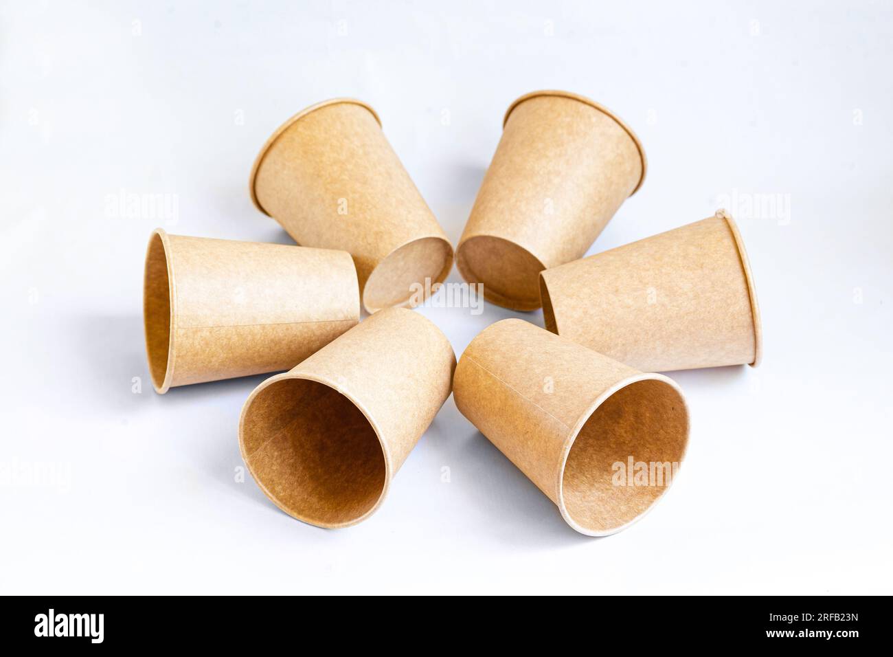Stack of paper mugs. Six disposable paper cups made of cardboard kraft ...