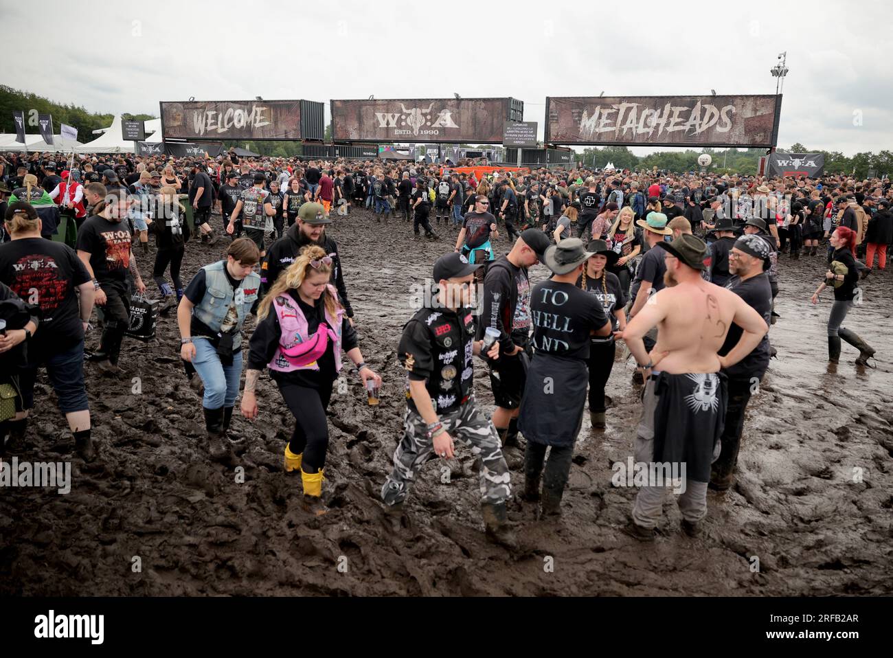 Wacken, Germany. 02nd Aug, 2023. Metal fans wait at one of the ...
