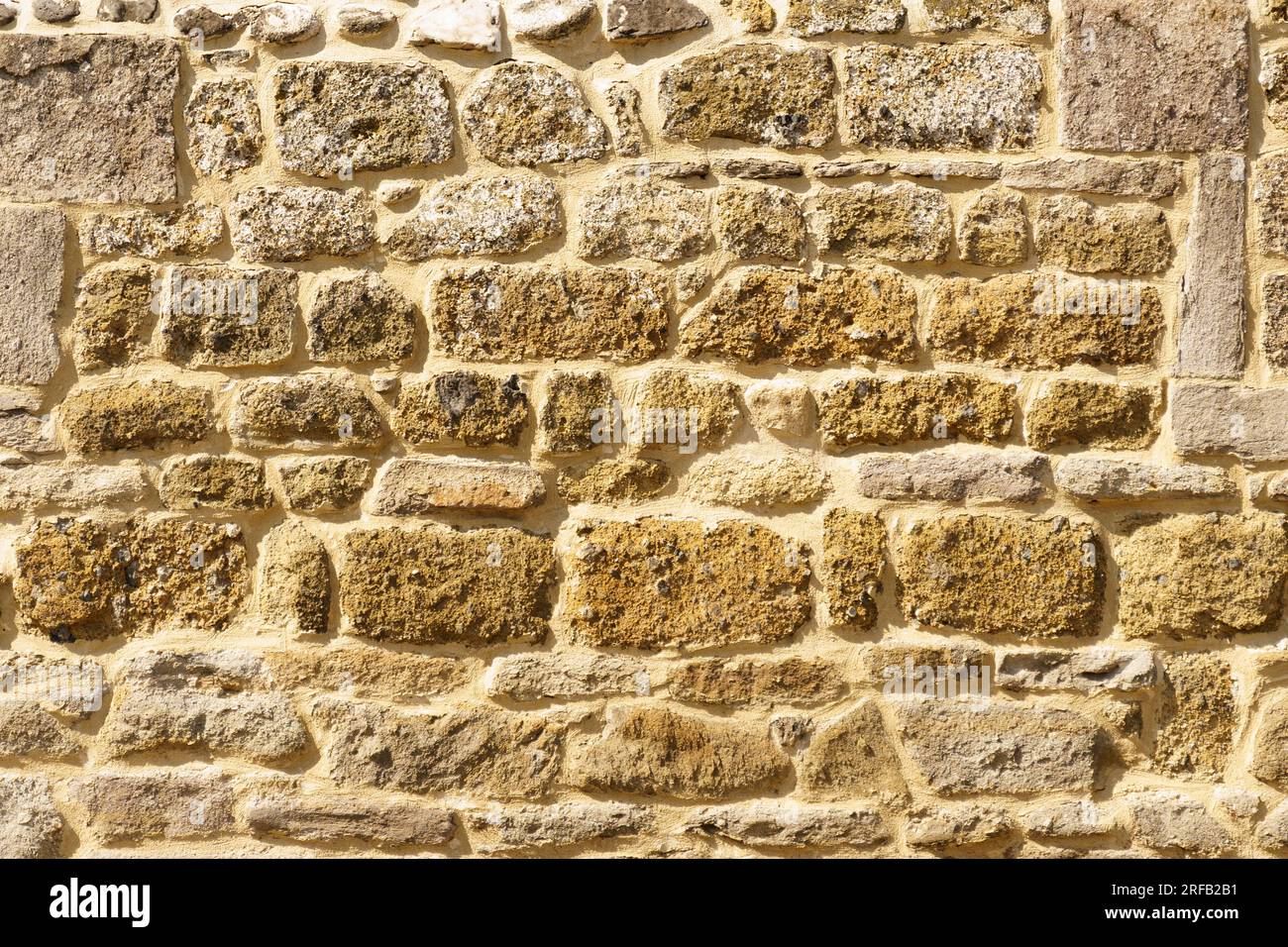 The texture of the old medieval wall of the house, lined with brown ...