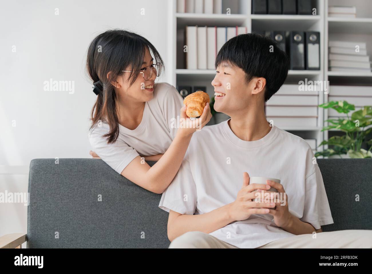 Young couples spend holidays in the living room. The young man was wearing comfortable clothes ...