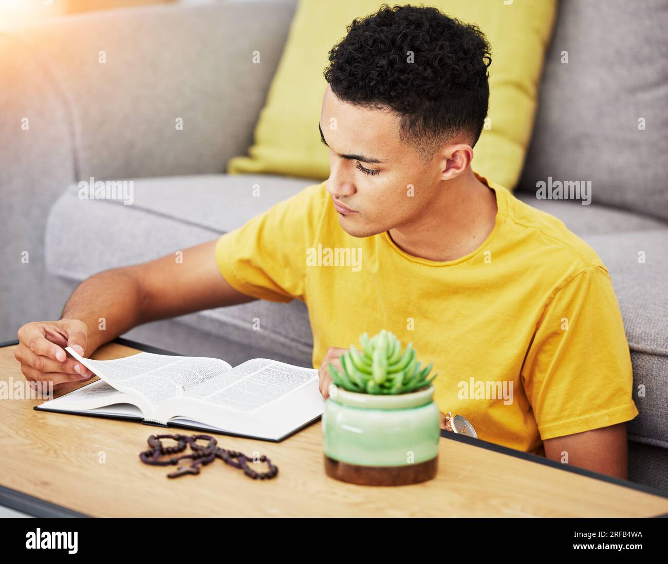 Prayer, reading and bible with man in living room for worship ...
