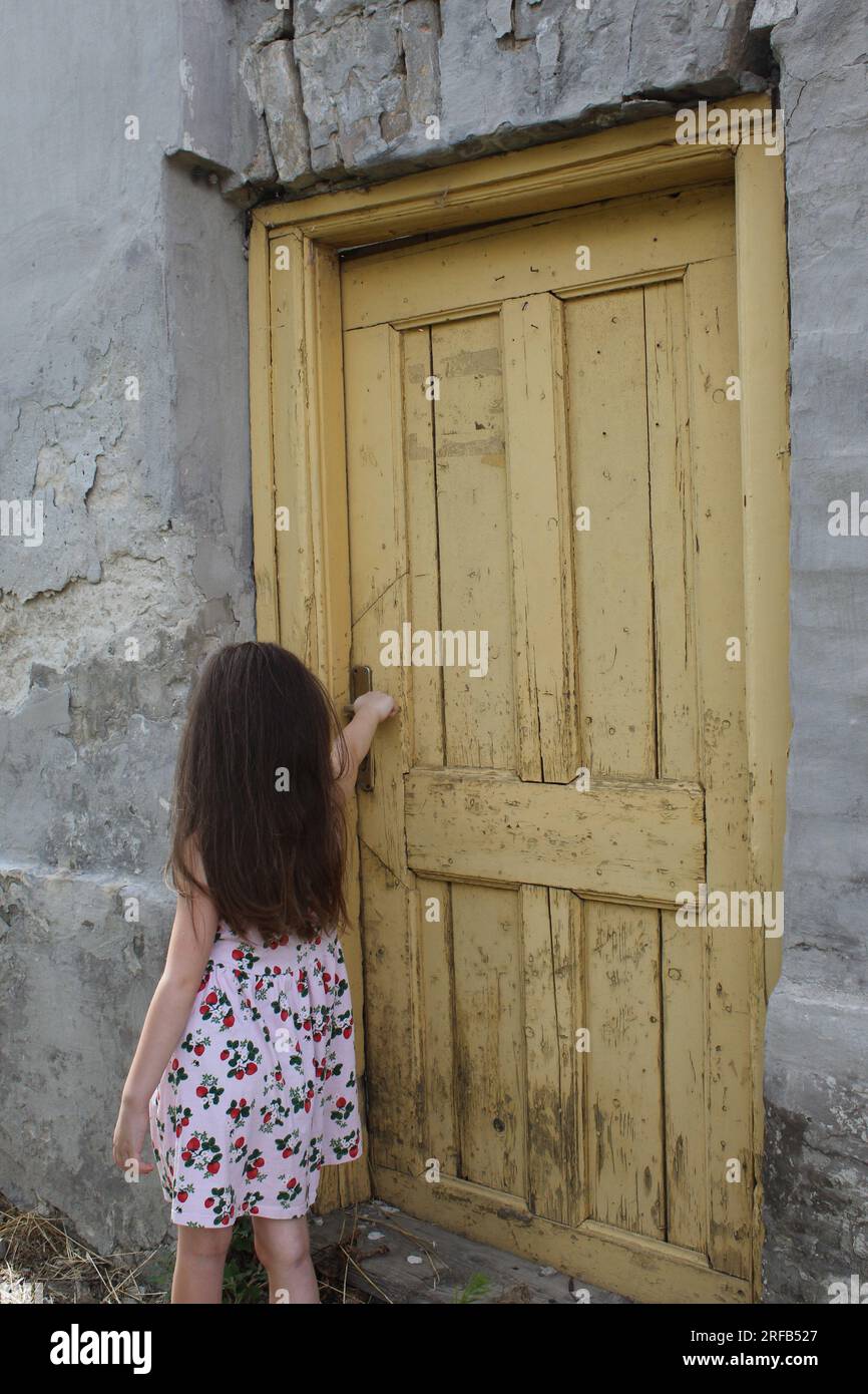 Old door , little girl Stock Photo - Alamy