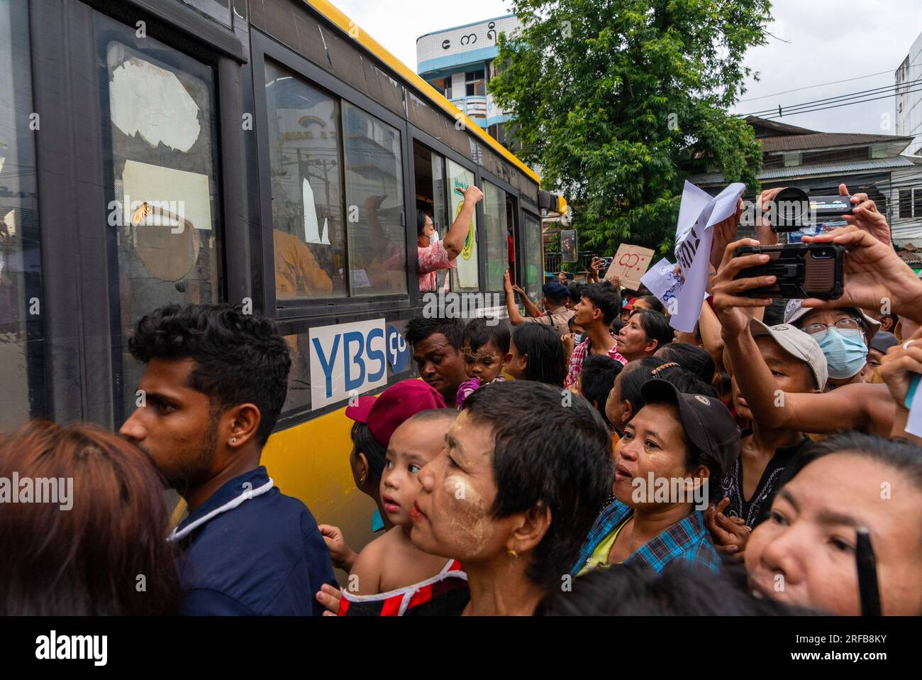 Yangon, Myanmar. 01st Aug, 2023. Family members gather around a bus ...