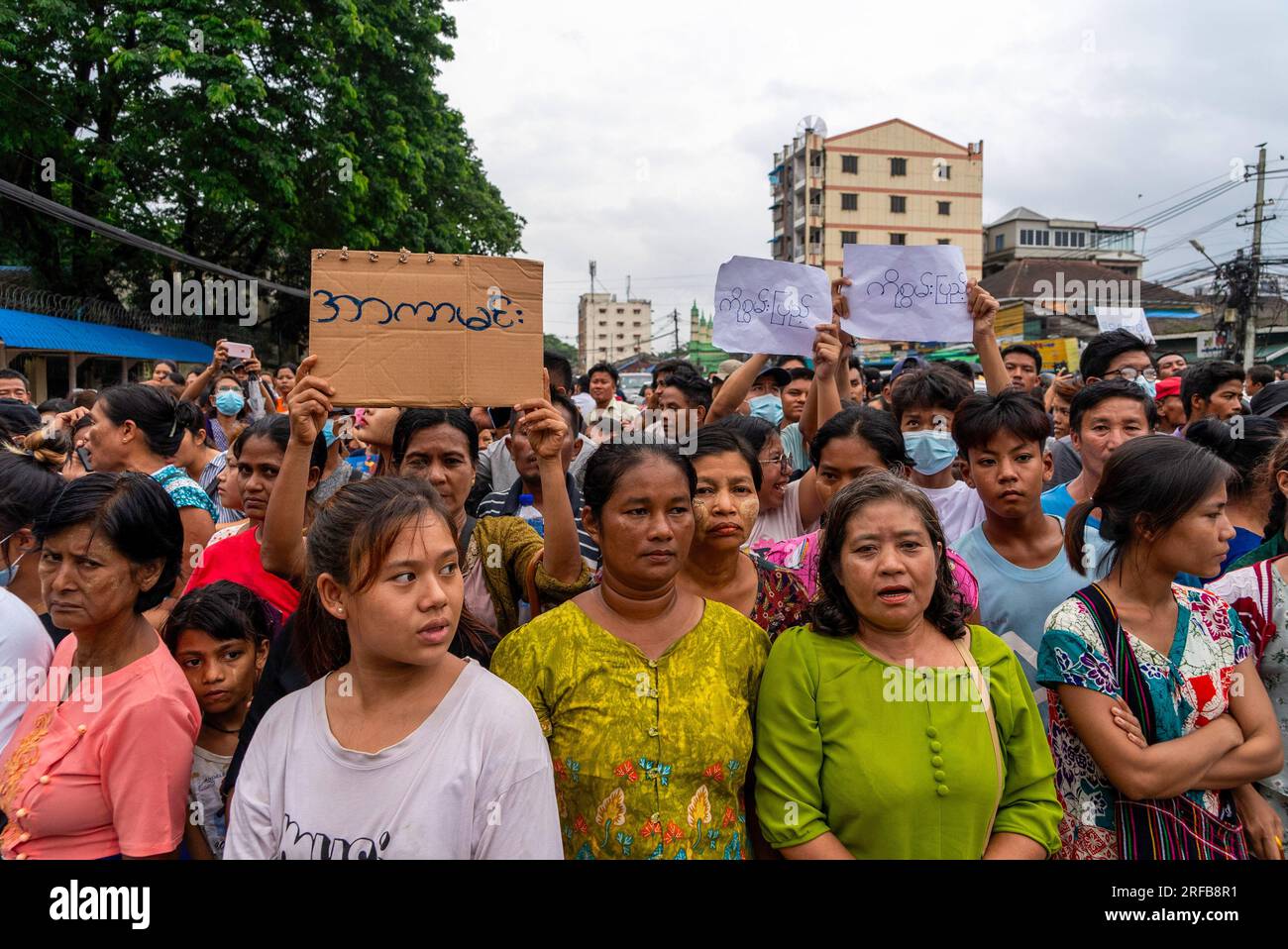 Family members hold placards as they gather outside the Insein ...