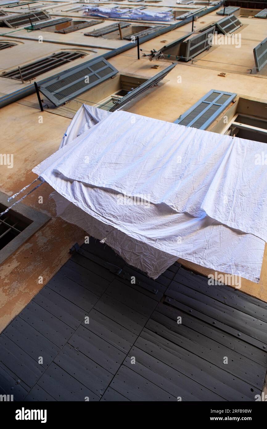 Laundry drying at the windows in a street Stock Photo - Alamy
