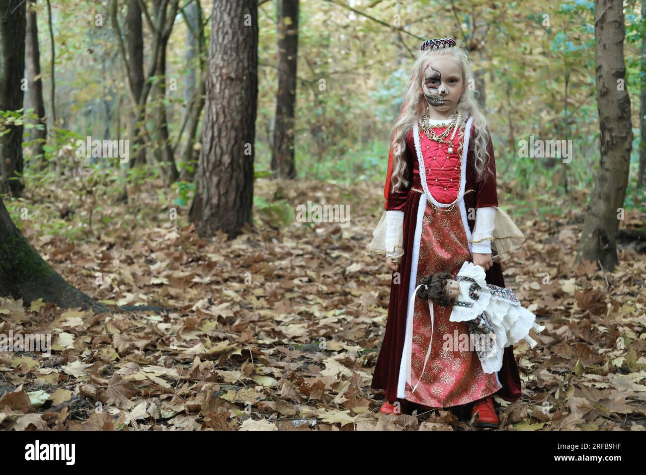 Girl child posing in the forest in a medieval dress in the image of a ...