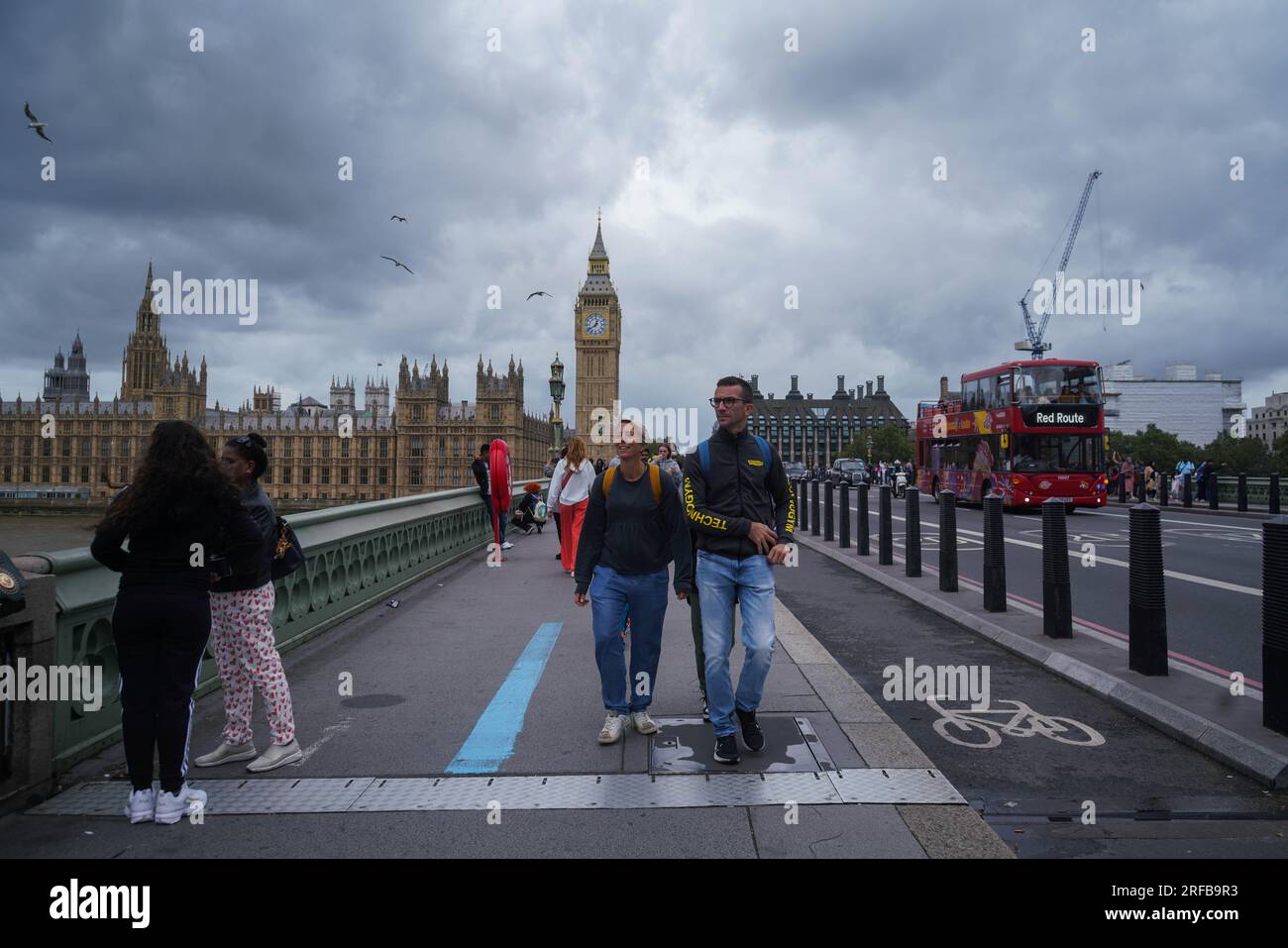London UK. 2 August 2023 Pedestrians on Westminster bridge brave the ...