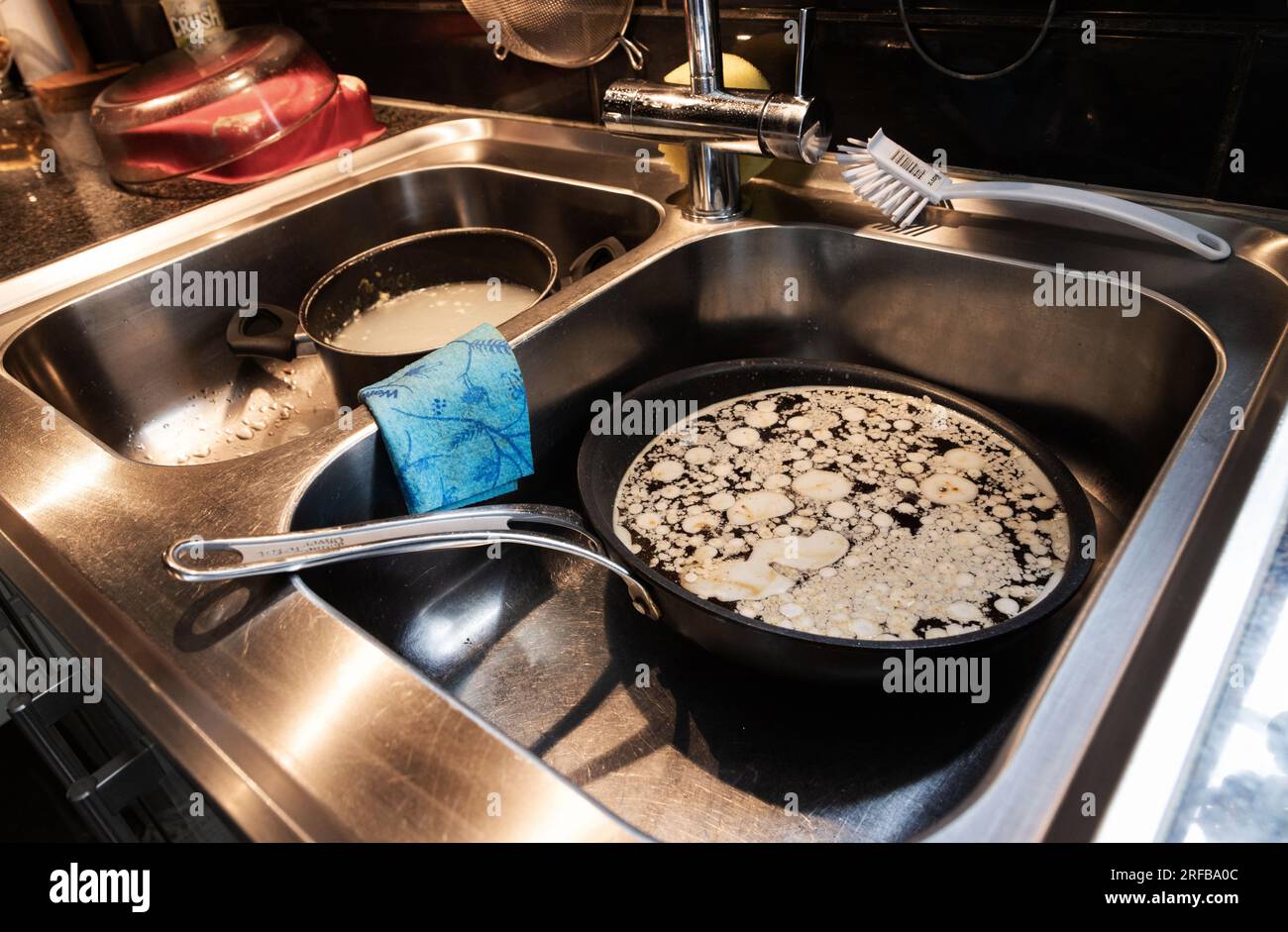 Cooking grease in a frying pan in the sink, after someone fried bacon ...