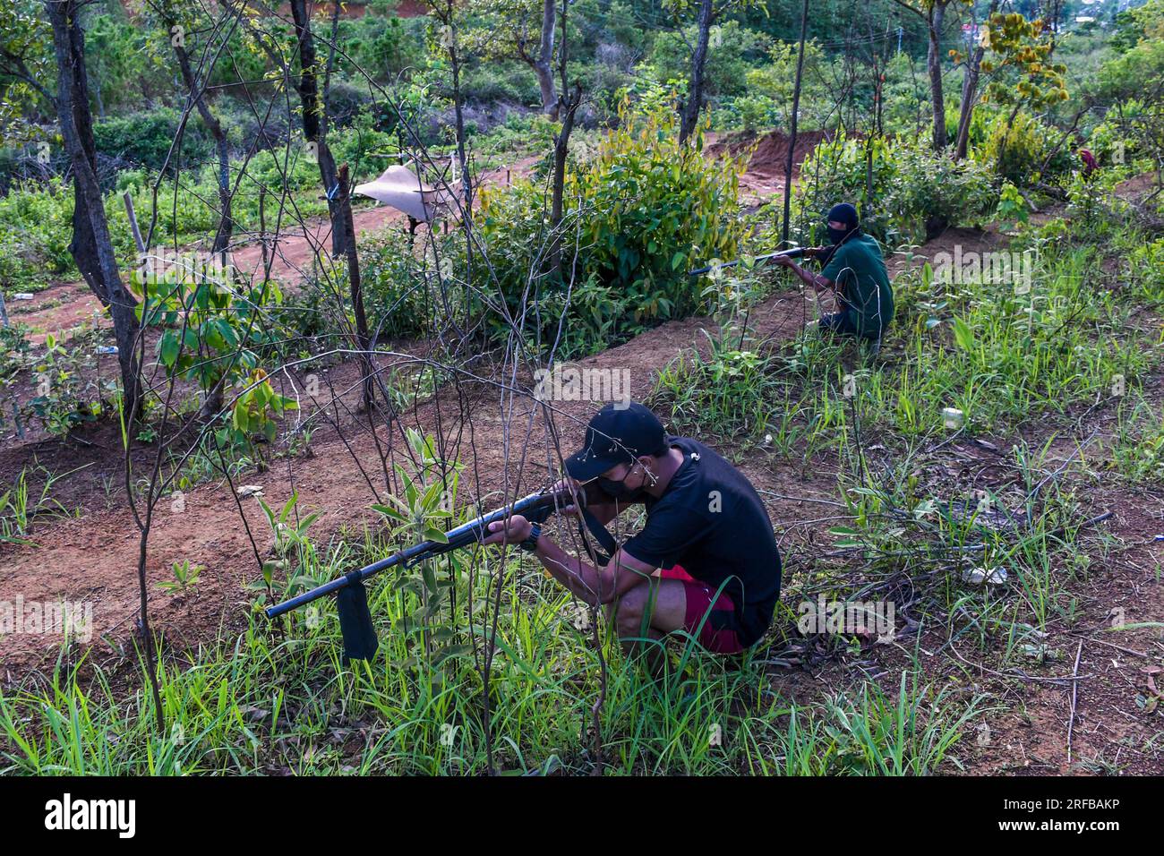 Armed Kuki youth take position while receiving basic firearms training ...