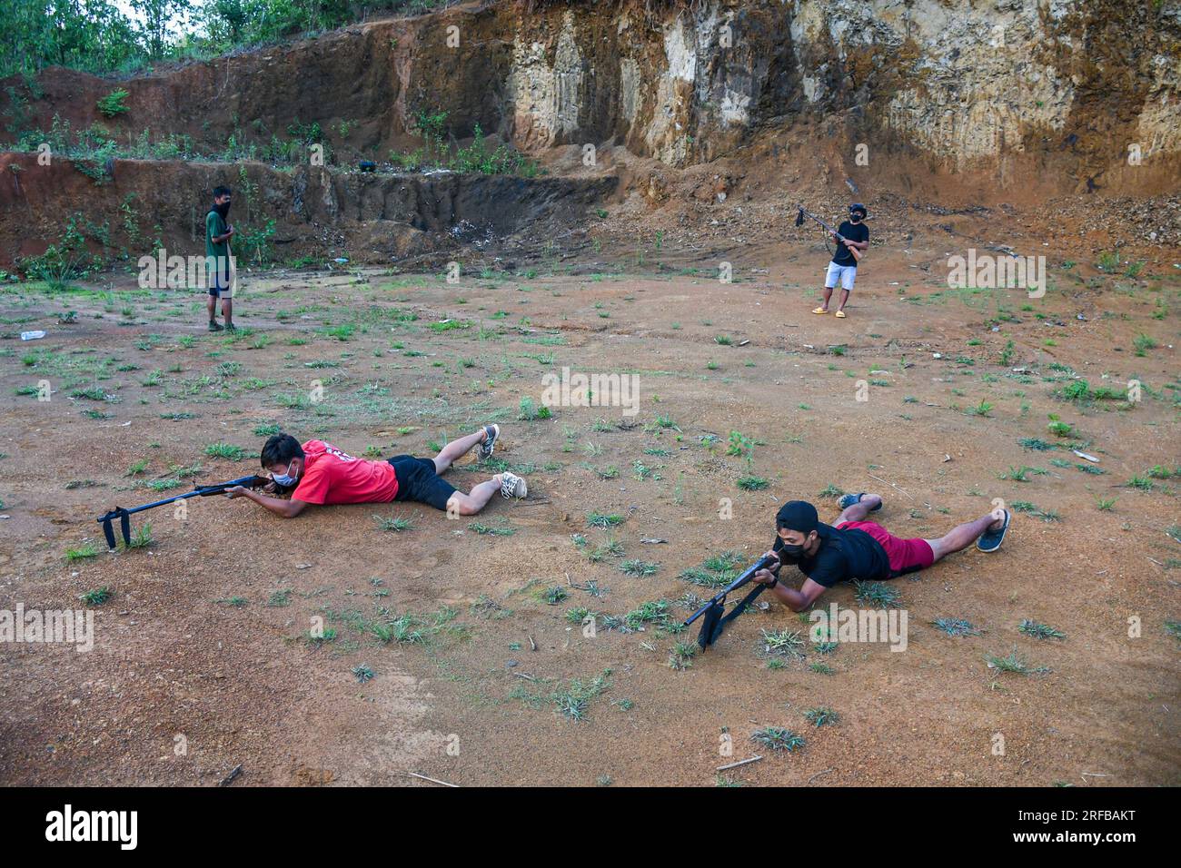 Armed Kuki youth take position while receiving basic firearms training ...