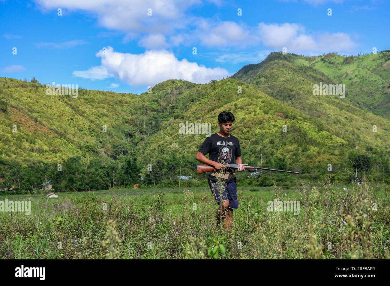 An armed Kuki man, walks as he guards a village in Churachandpur ...