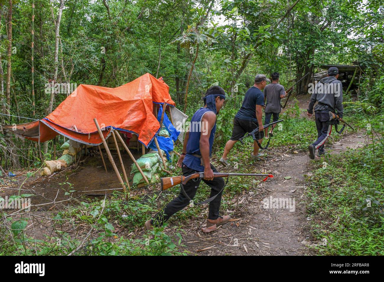 Armed Kuki men arrive to guard a village in Churachandpur district in ...