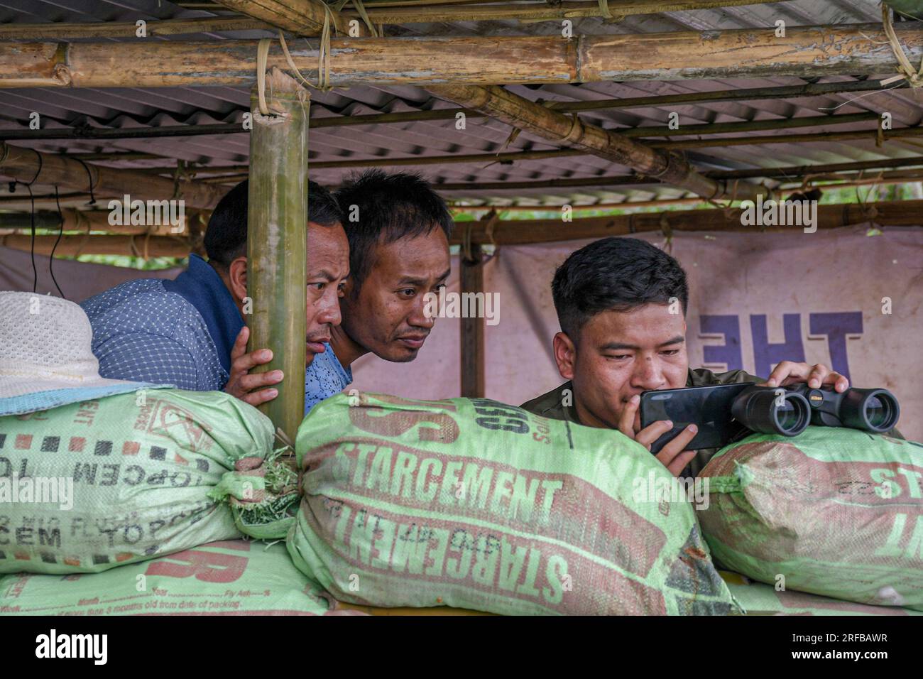 Members of the Kuki–Zo tribe monitor the positions of bunkers belonging ...