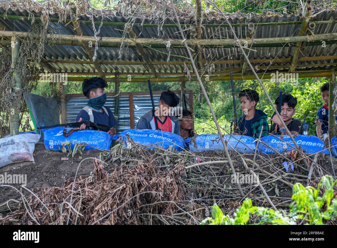 Armed Kuki boys guard a village in a bunker in Churachandpur district in the northeastern state ...