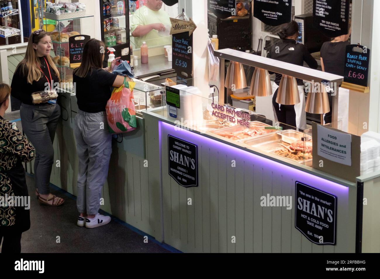 Queuing for lunch at one of the many food stalls in Cardiff Market ...