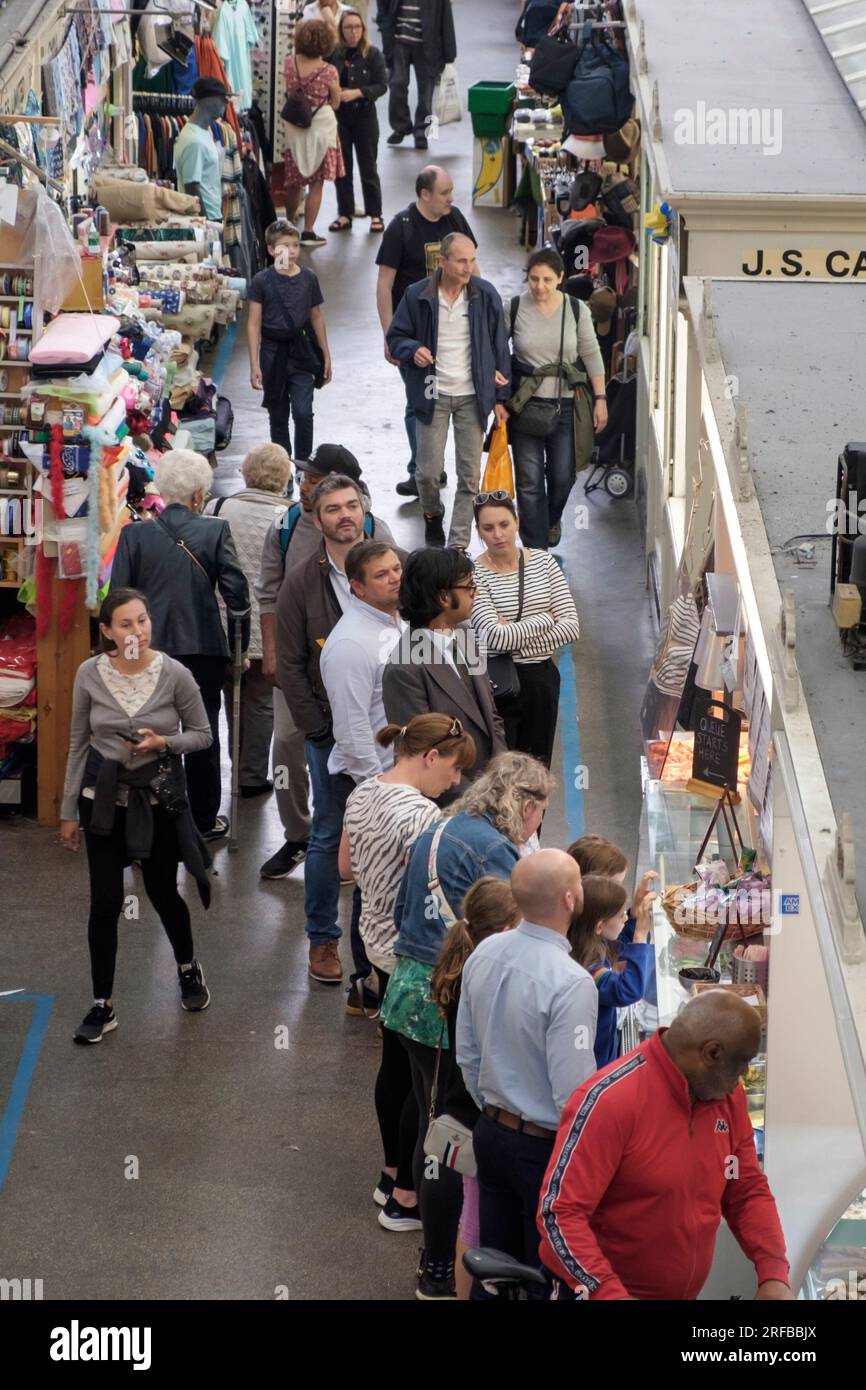Queuing for lunch at one of the many food stalls in Cardiff Market ...