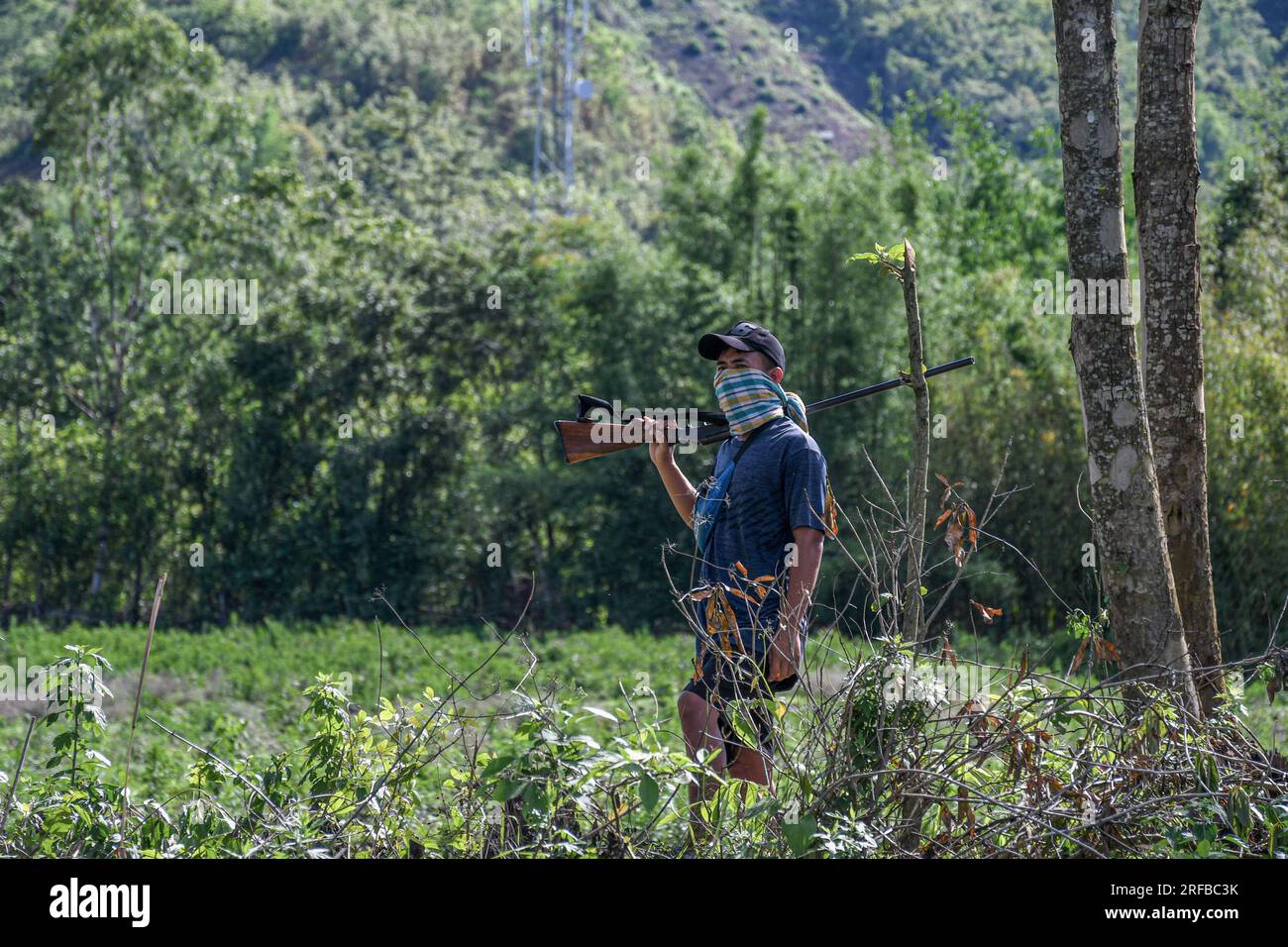 An armed Kuki man guards a village in Churachandpur district in the ...