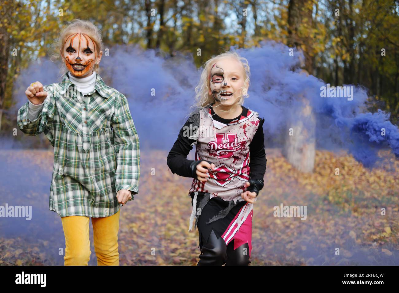 Two children girls girlfriends in Halloween costumes and with makeup ...