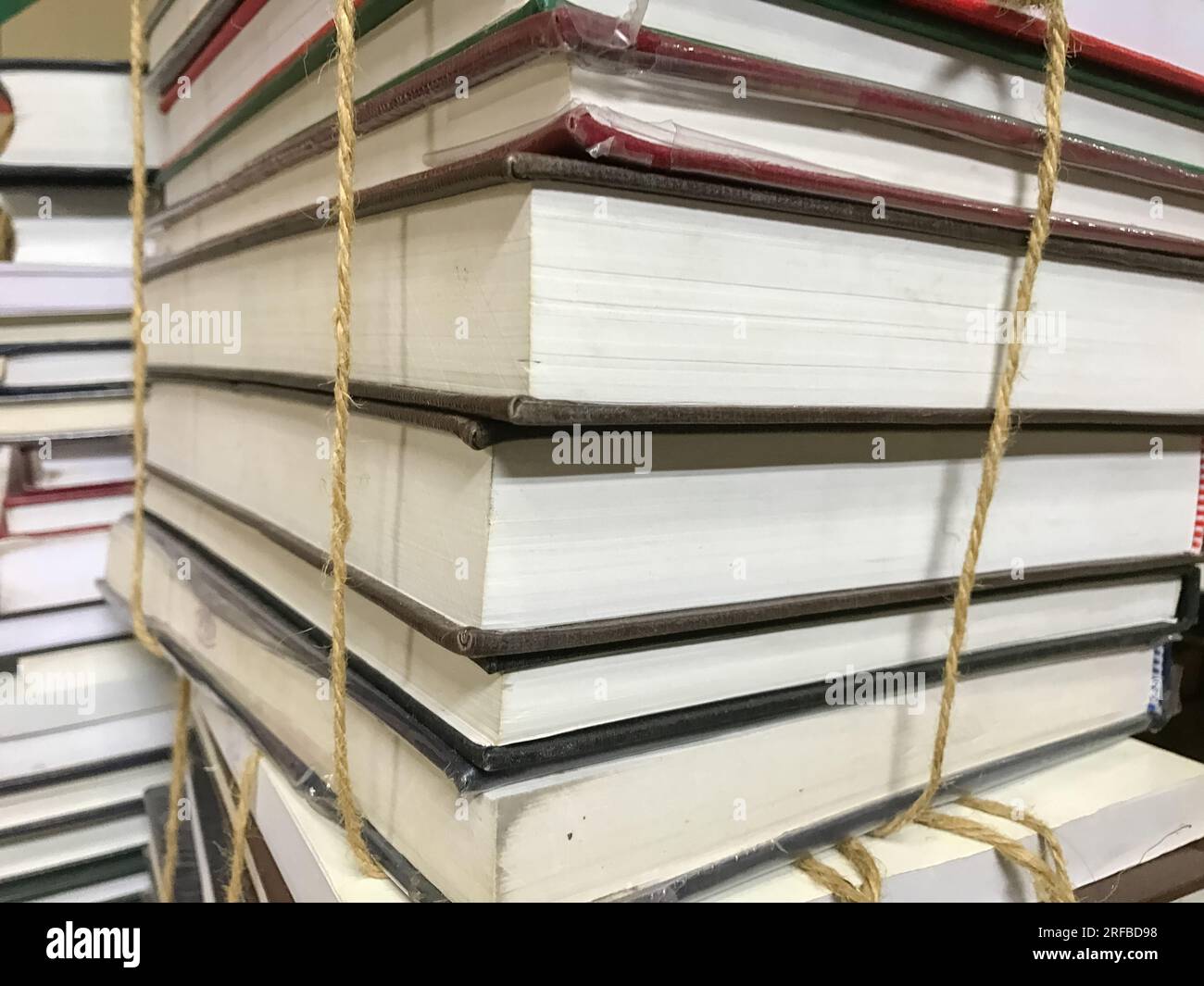 Pile of old books with rope background Stock Photo - Alamy