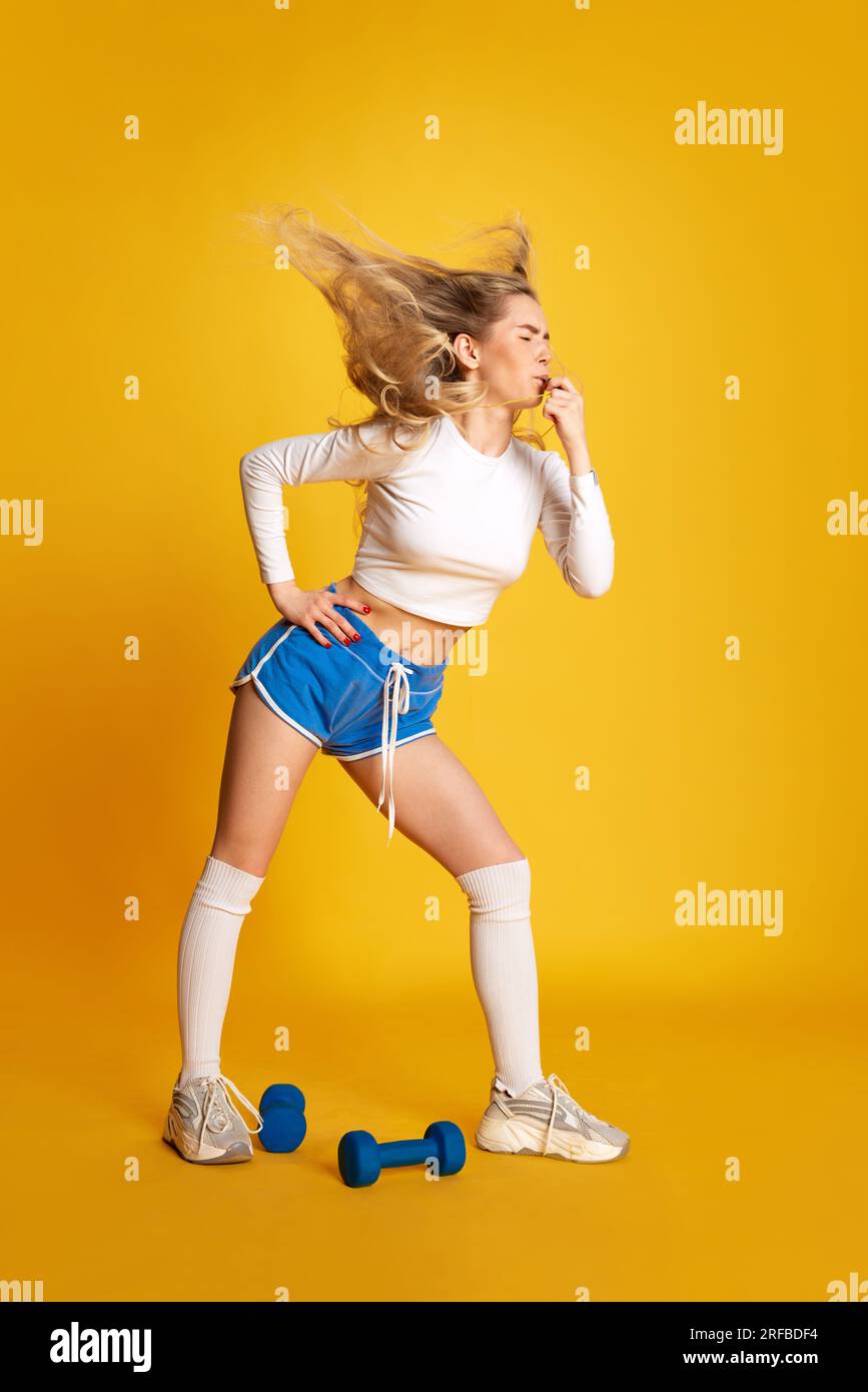 Full body shoot of young strong woman wear sporty with windblown hair ...