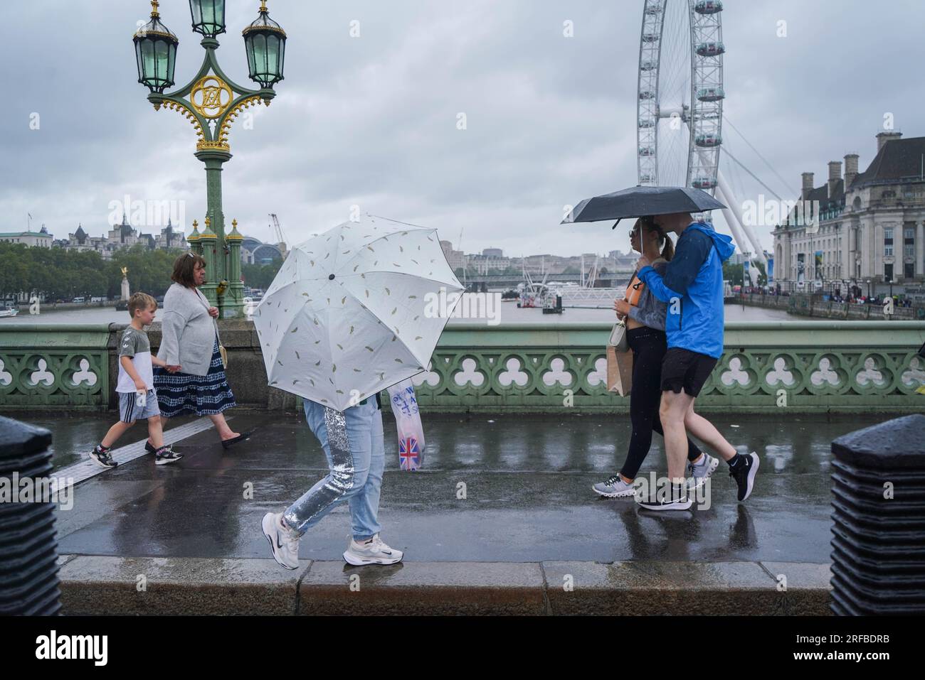 London UK. 2 August 2023 Pedestrians on Westminster bridge brave the ...