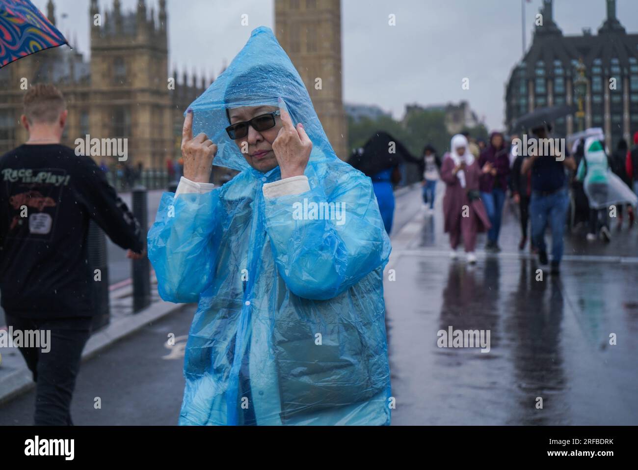 London UK. 2 August 2023 Pedestrians on Westminster bridge brave the ...