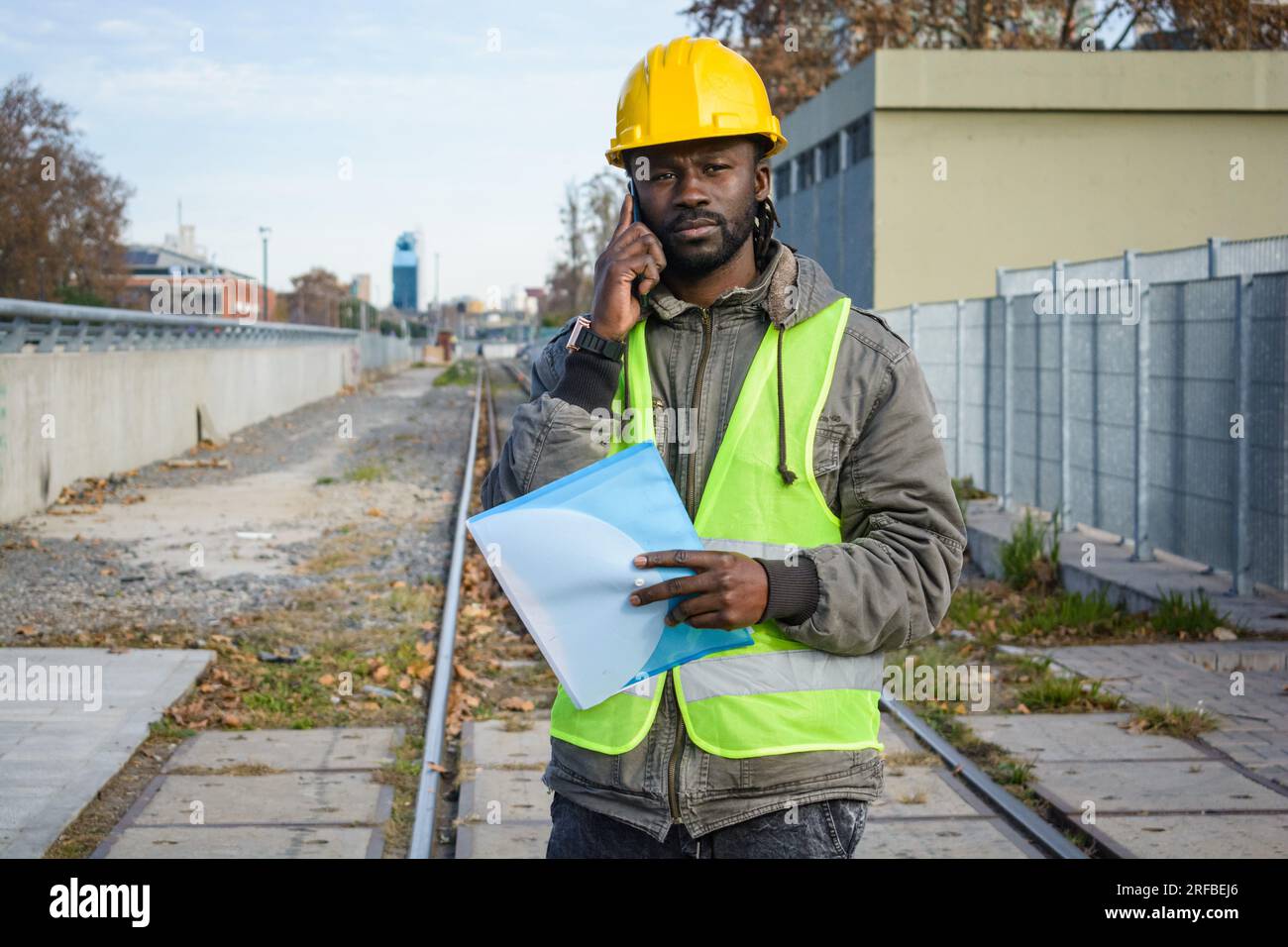 portrait of black man maintenance worker wearing helmet and reflective ...