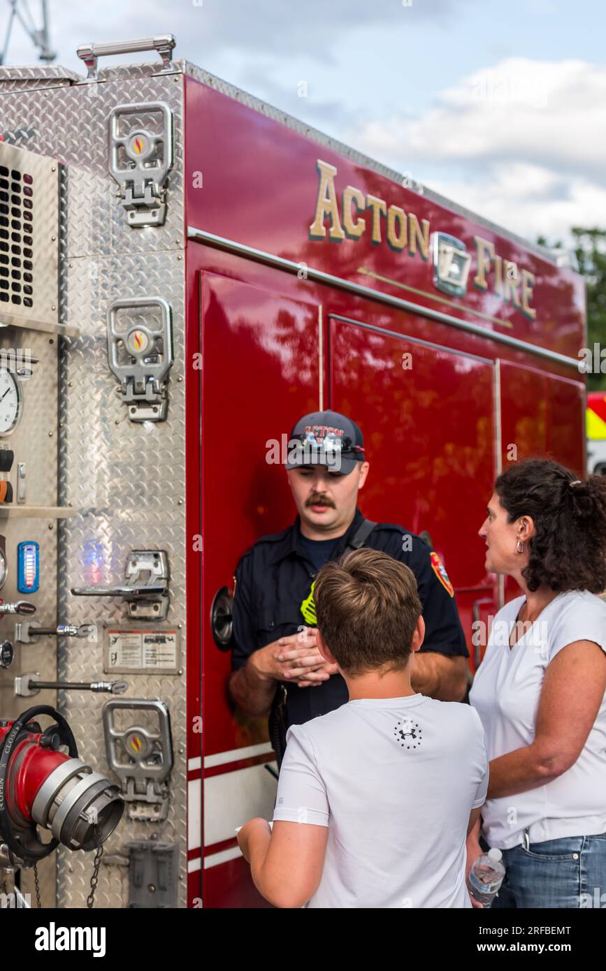 Acton firefighter talking with woman and child from community at Acton ...