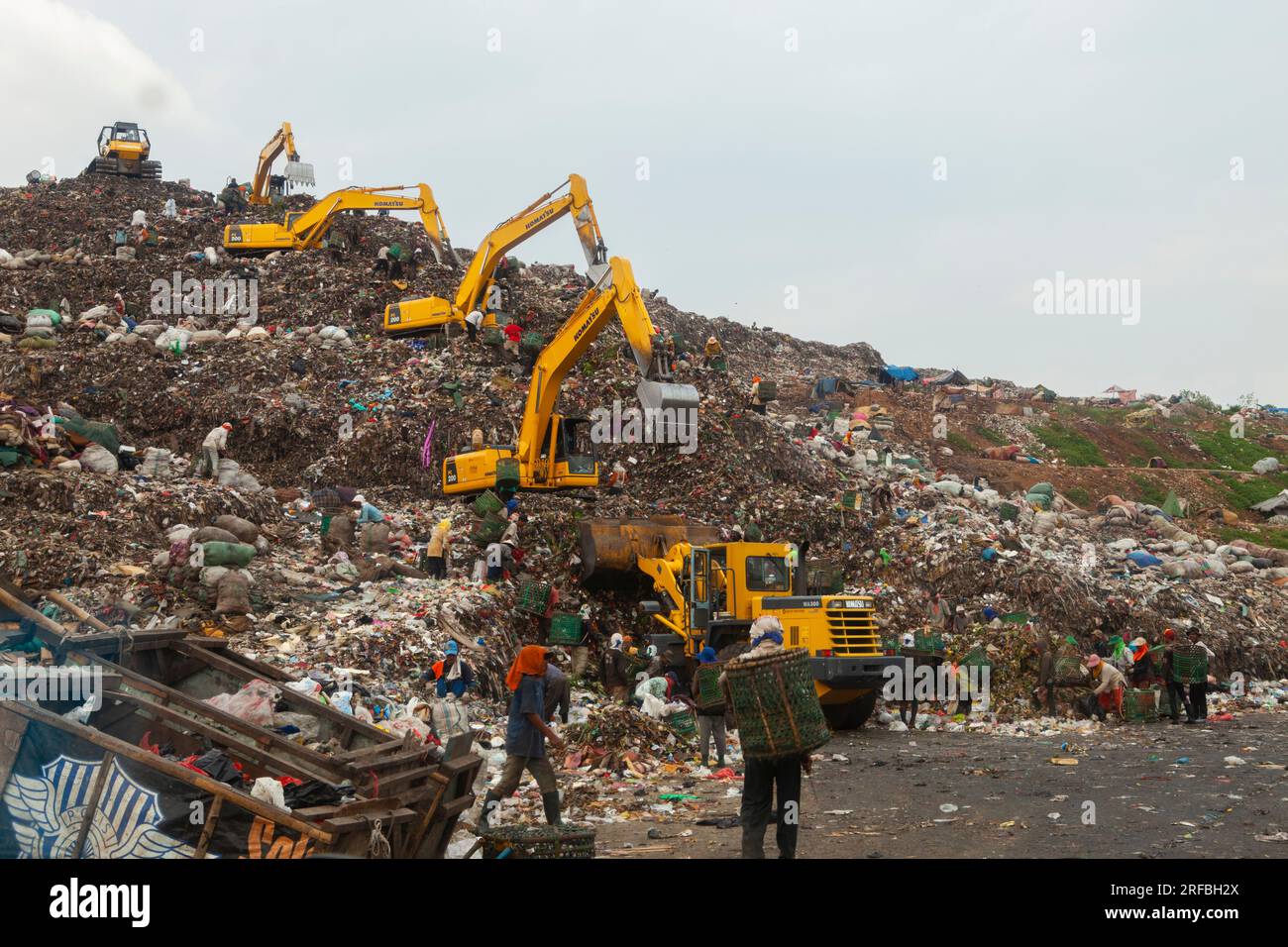 The atmosphere of a landfill called Bantar Gebang with workers ...