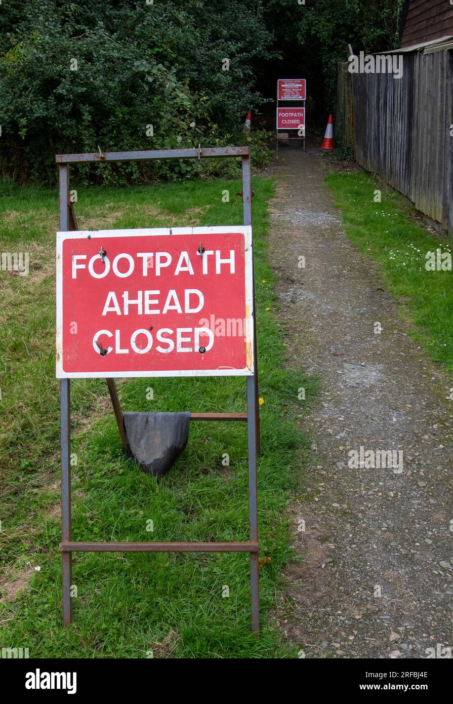A red and white sign warning that a public footpath is closed for works ...