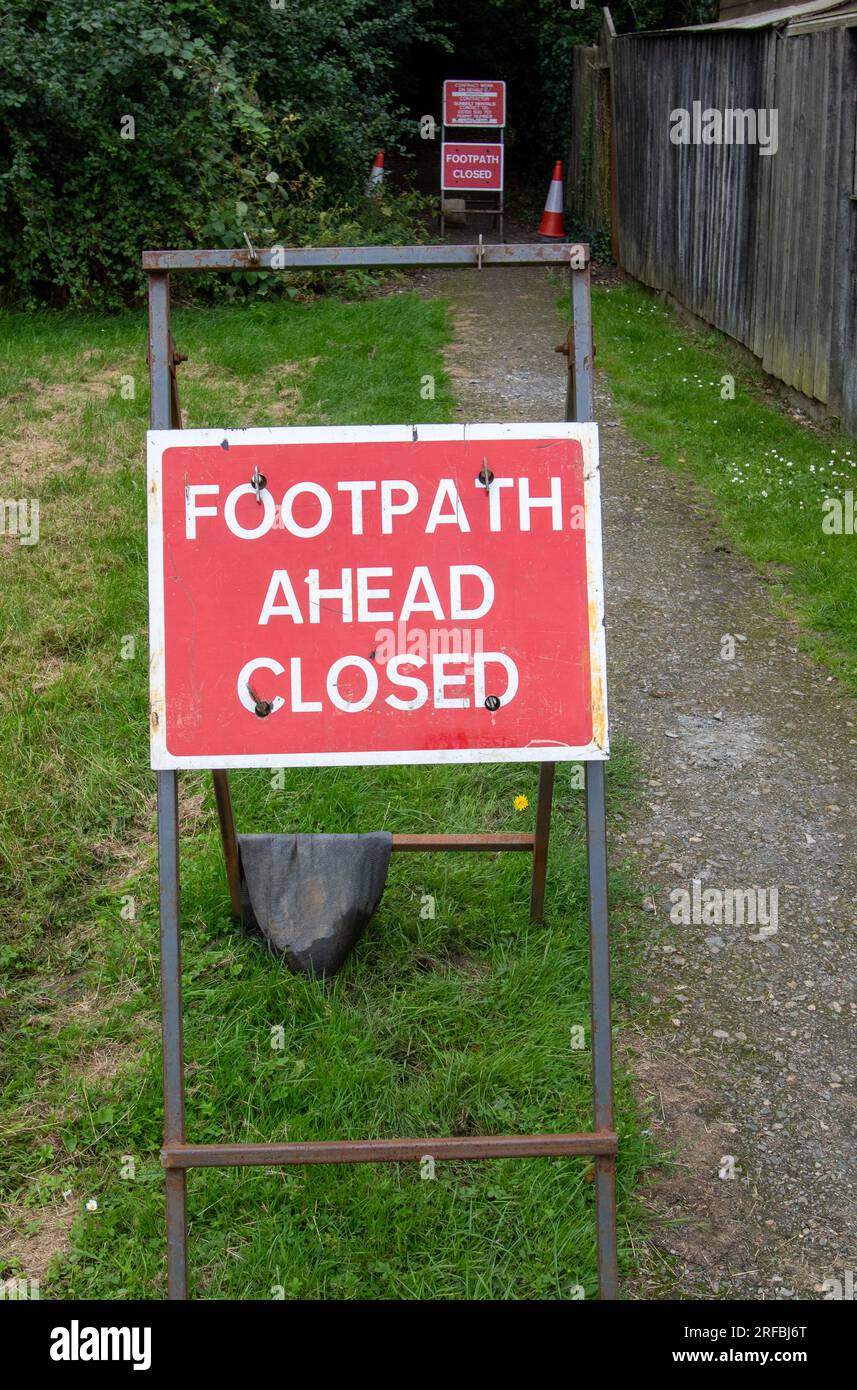 A red and white sign warning that a public footpath is closed for works ...