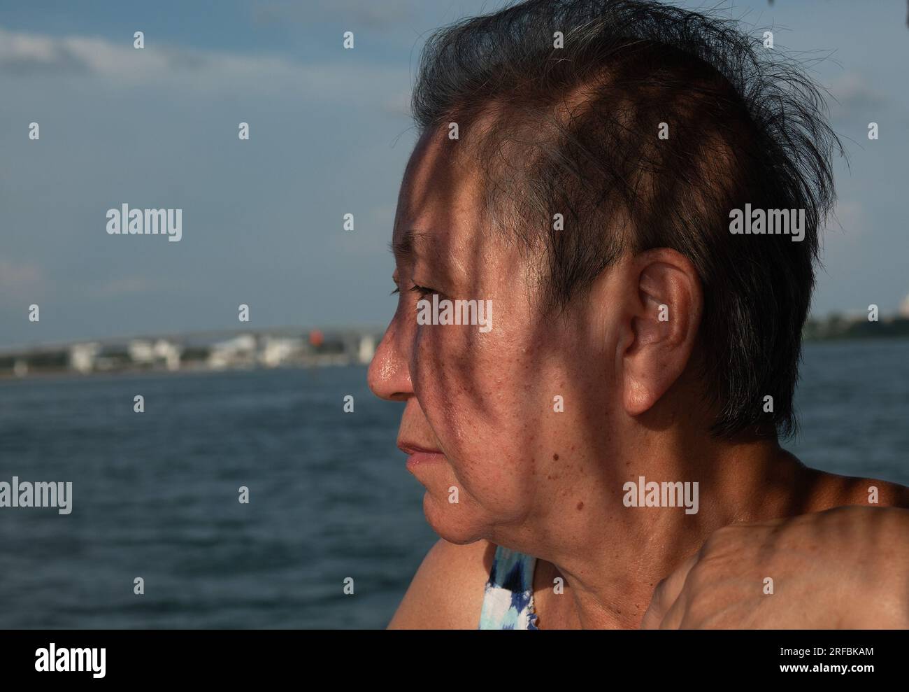 Woam with the shadow of a palm tree on her face Stock Photo - Alamy