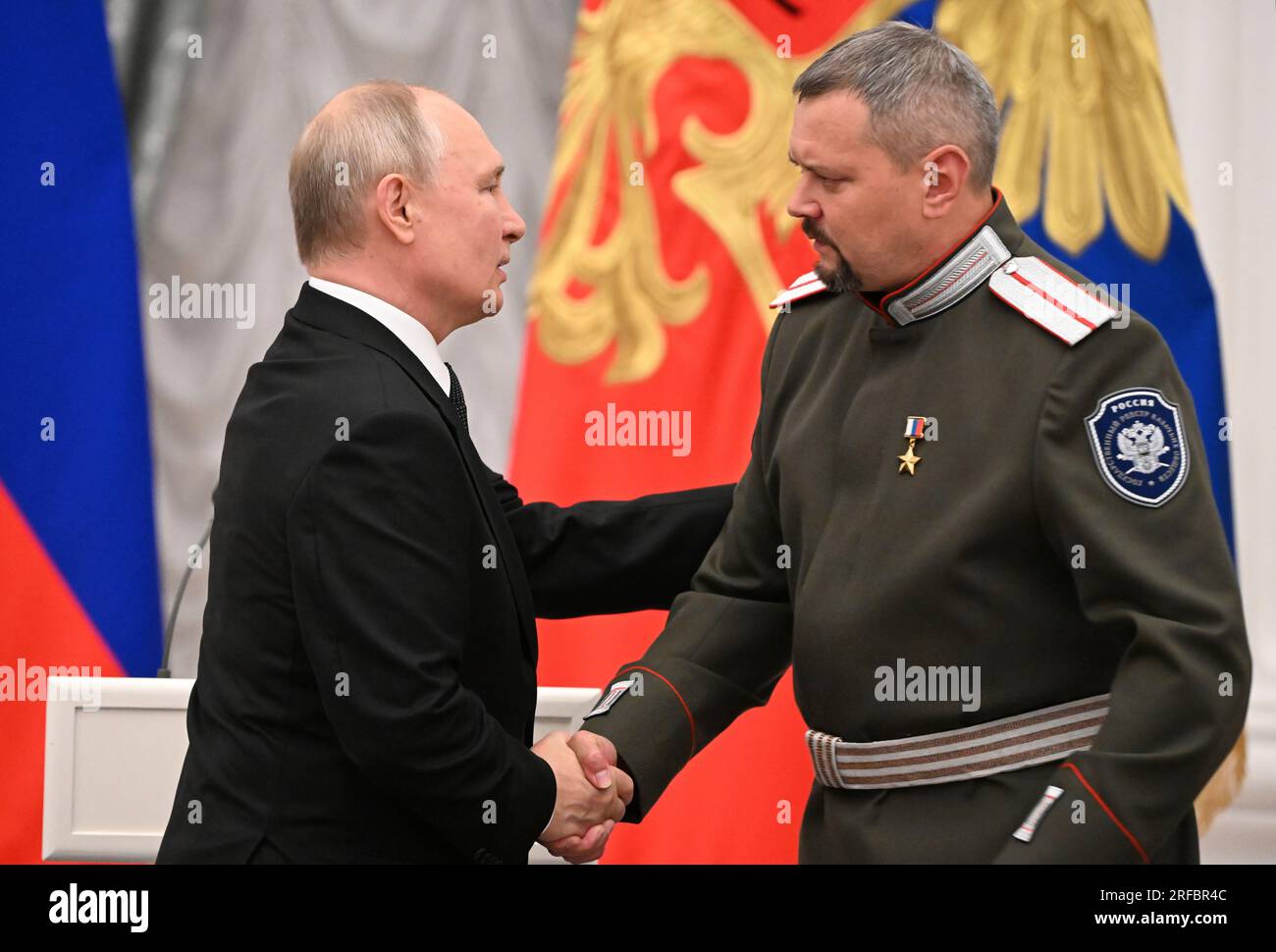 Russian President Vladimir Putin awards the commander of the volunteer ...