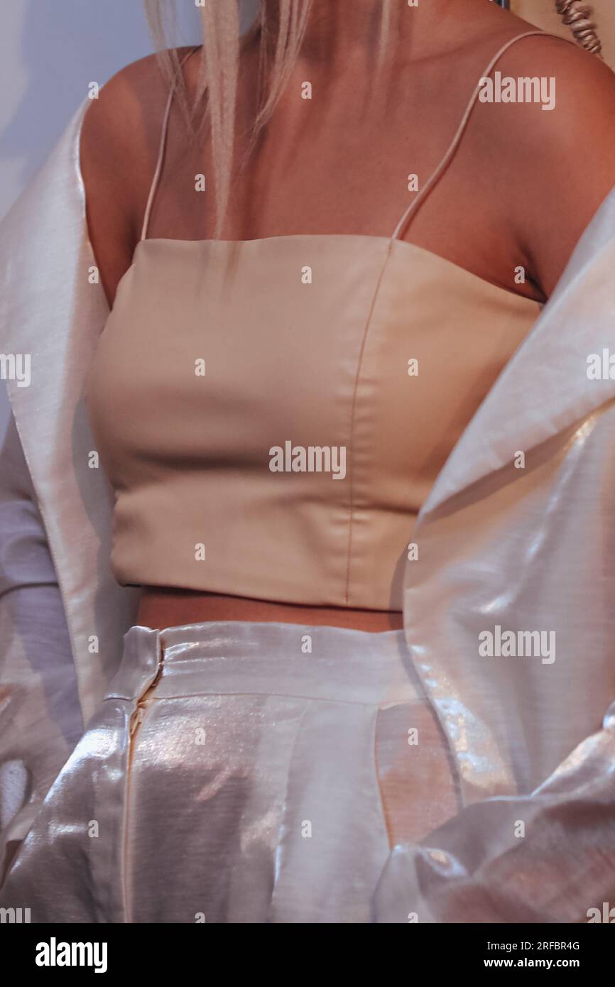 Cropped figure of fashion model woman wearing trendy white costume ...