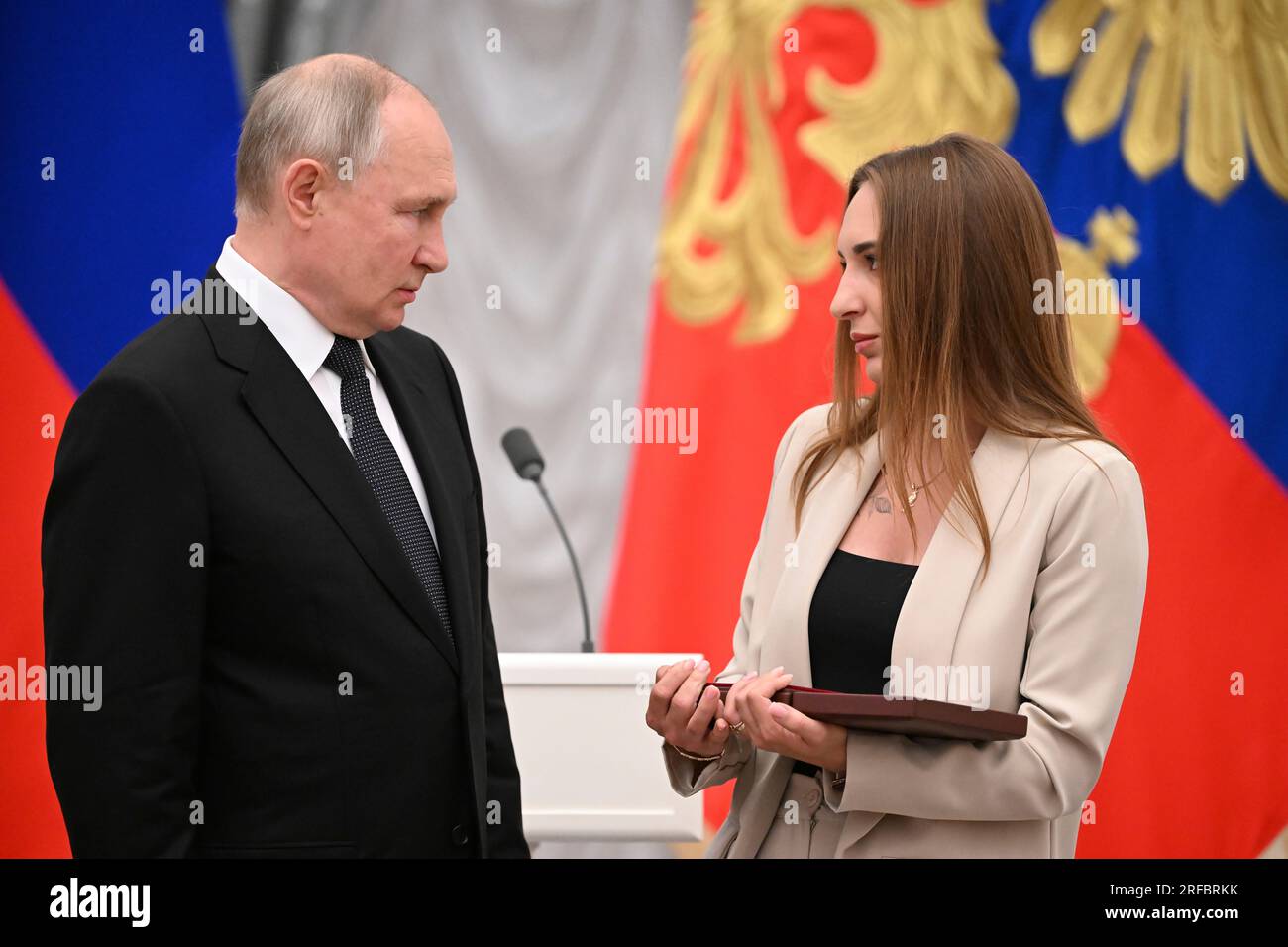 Russian President Vladimir Putin gives an award to the widow of Captain Roman Vorobyev ...
