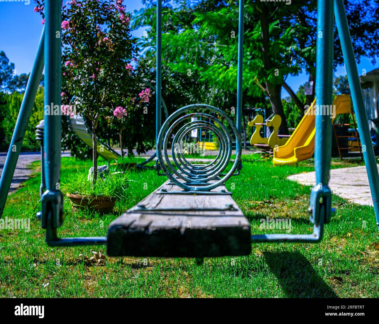 Childrens swing on playground hi-res stock photography and images - Alamy