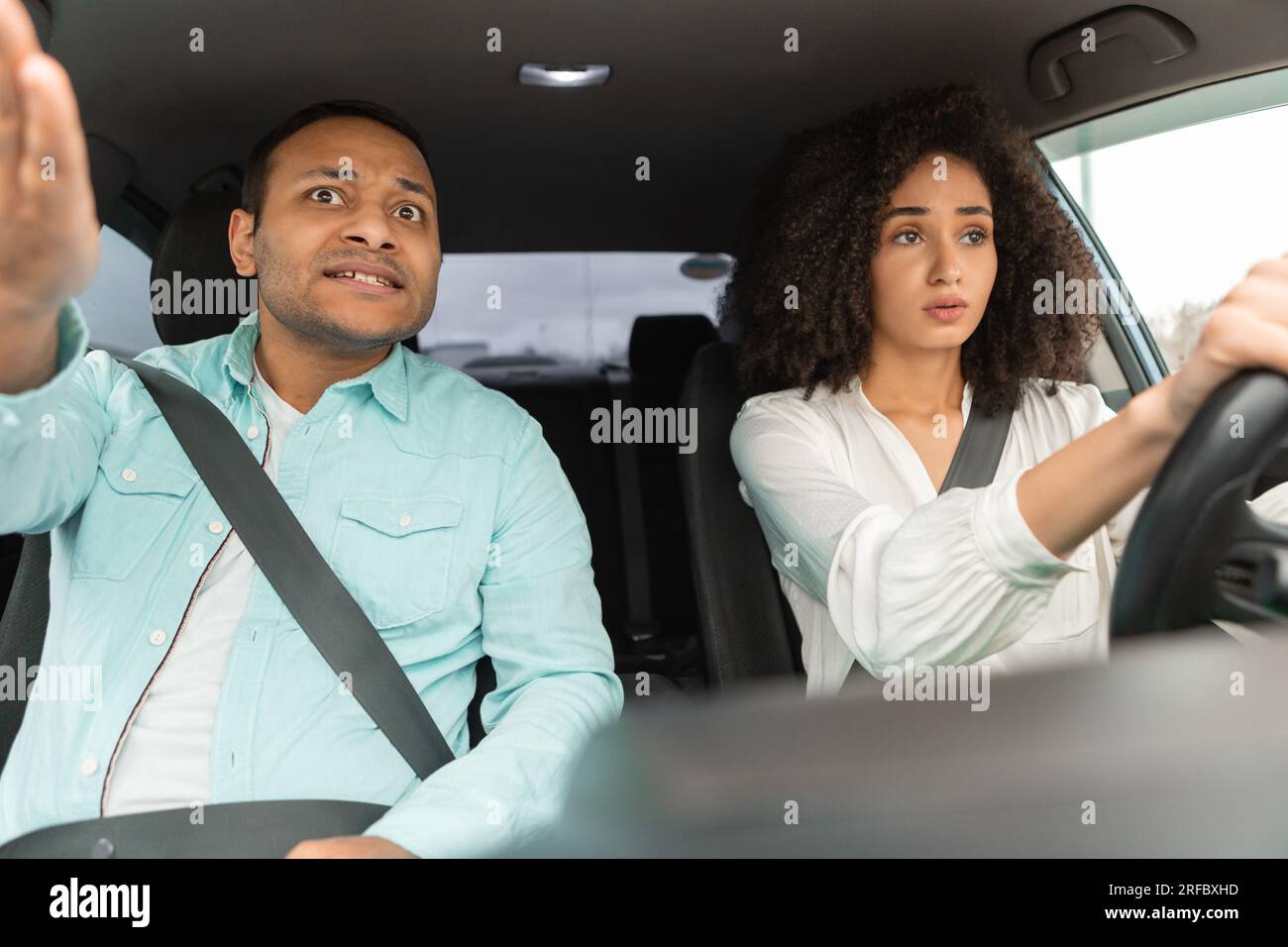 Woman Learning To Drive Car With Discontented Driving Teacher Man Stock ...