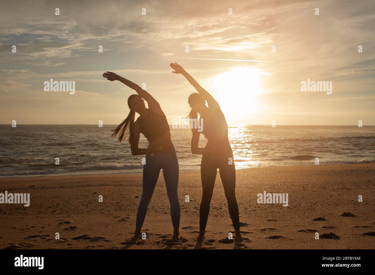 Millennial caucasian twins sisters women practice yoga, enjoy breathing ...