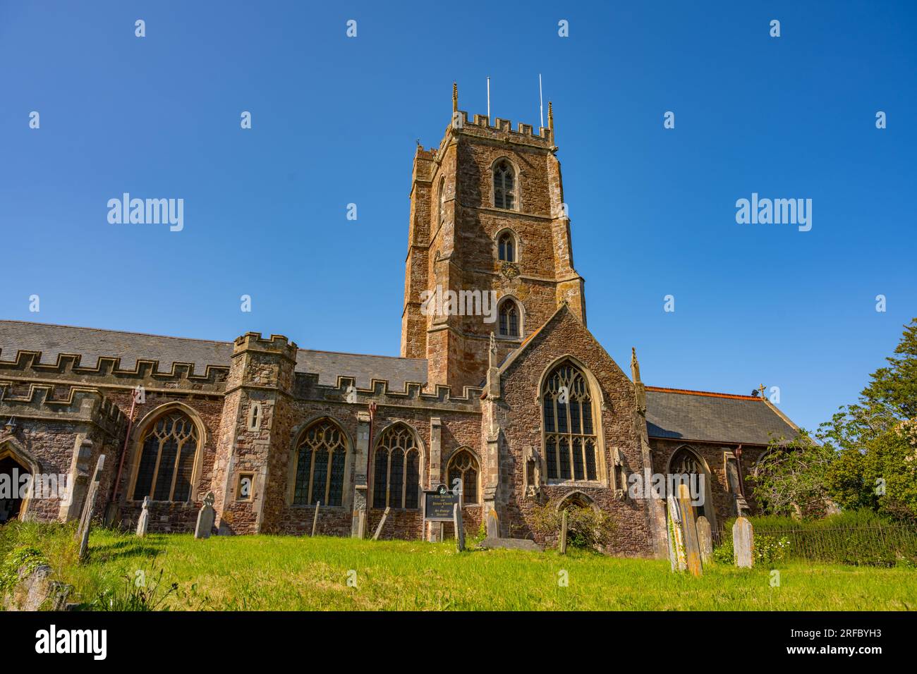 The tower and churchyard of St Georges church Dunster, Somerset Stock ...