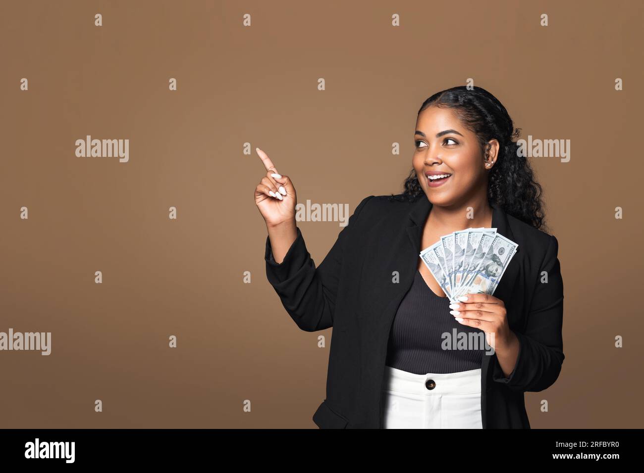 Happy latin plus size lady holding dollar cash fan in her hand and ...