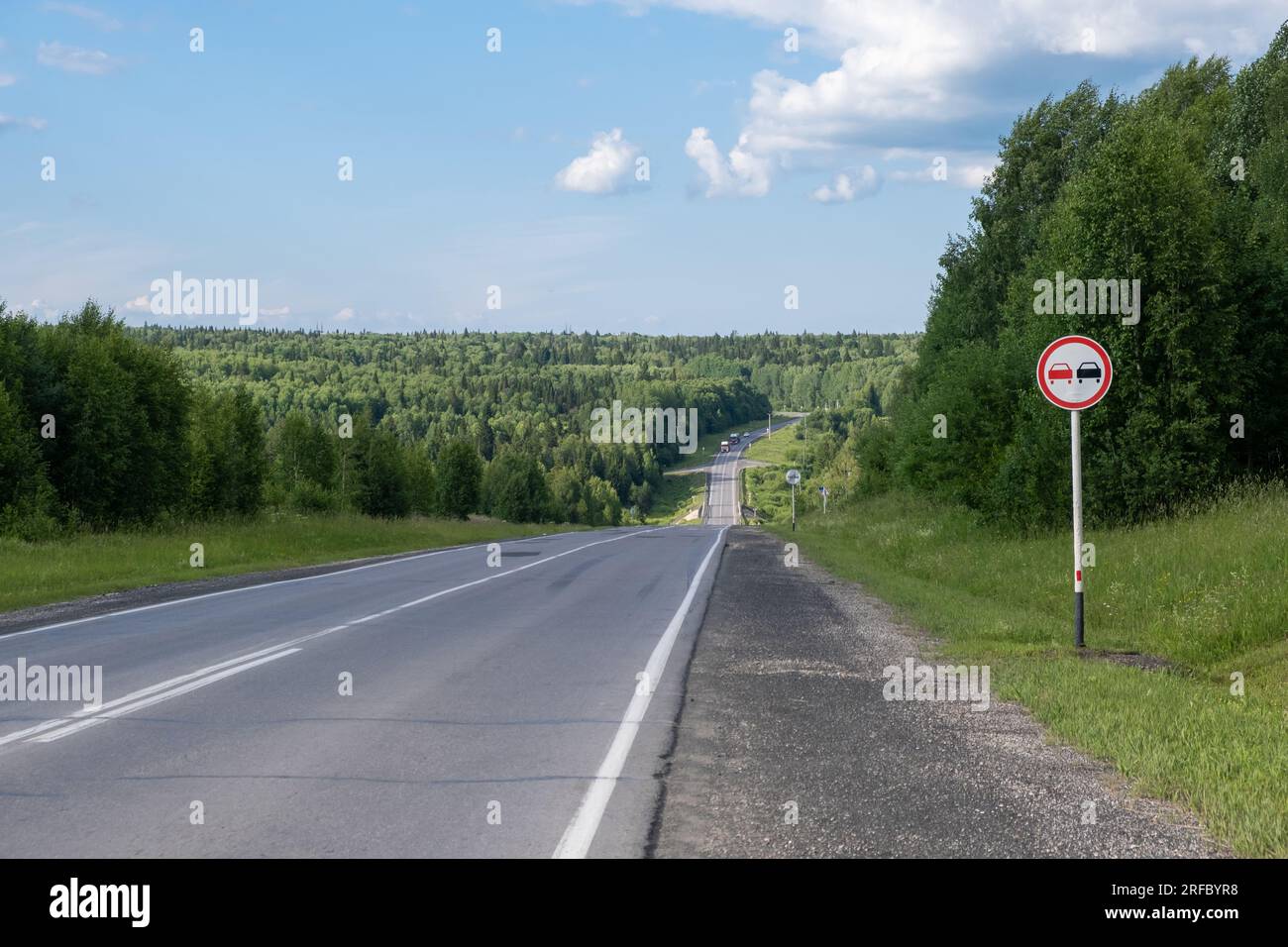 A road sign Overtaking is prohibited on a suburban highway through ...