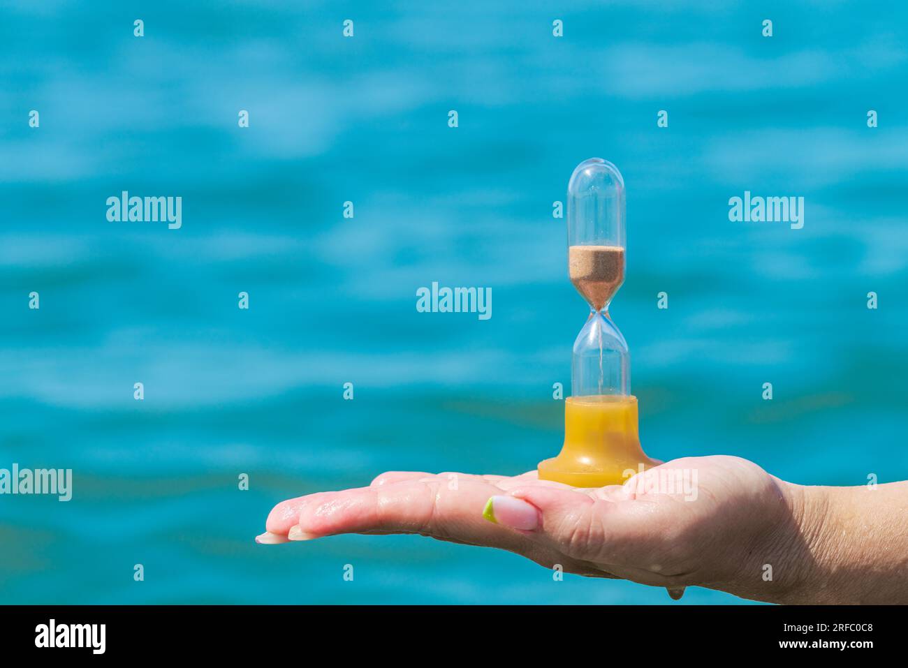 Sand running through an old hourglass measuring passing time and ...