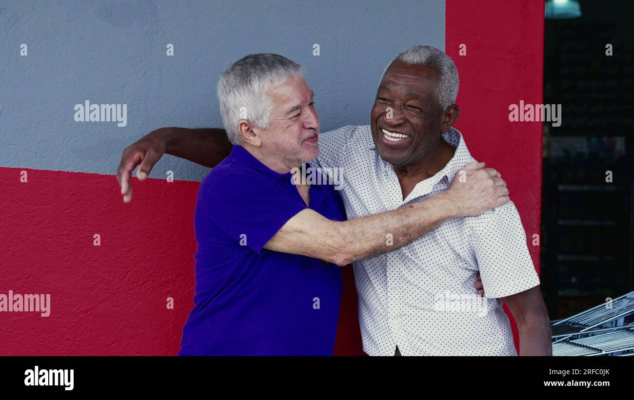 Authentic Interaction of Two Happy Diverse Older Friends, Hugging and ...