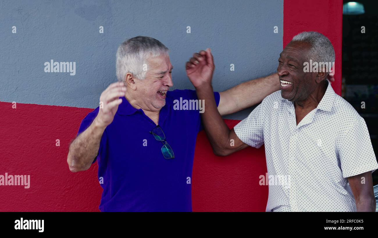 Authentic Interaction of Two Happy Diverse Older Friends, Hugging and ...