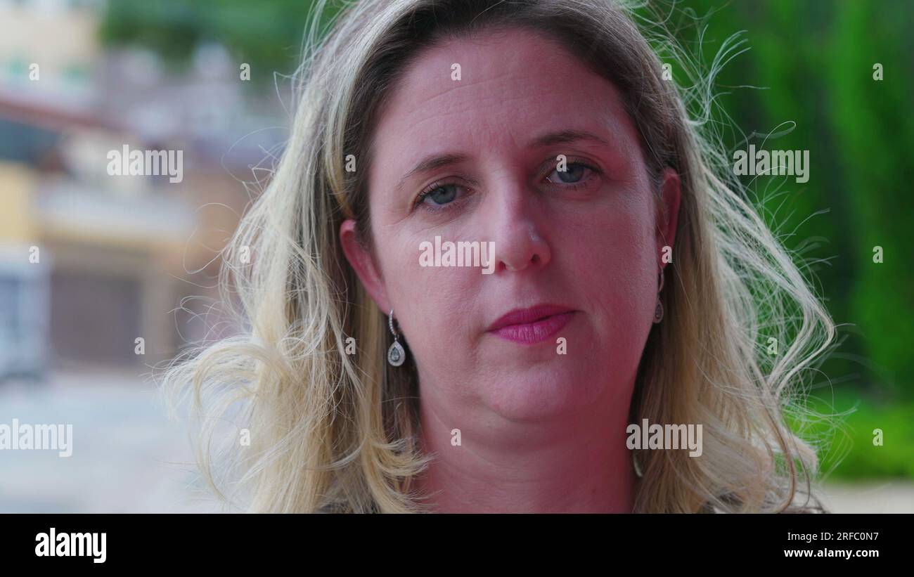 Close-up face of a woman in mid 40s looking at camera with serious ...