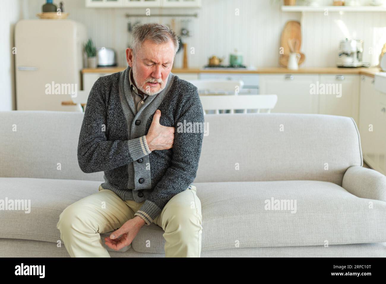 Pain on heart, heart attack. Unhappy middle aged senior man suffering ...