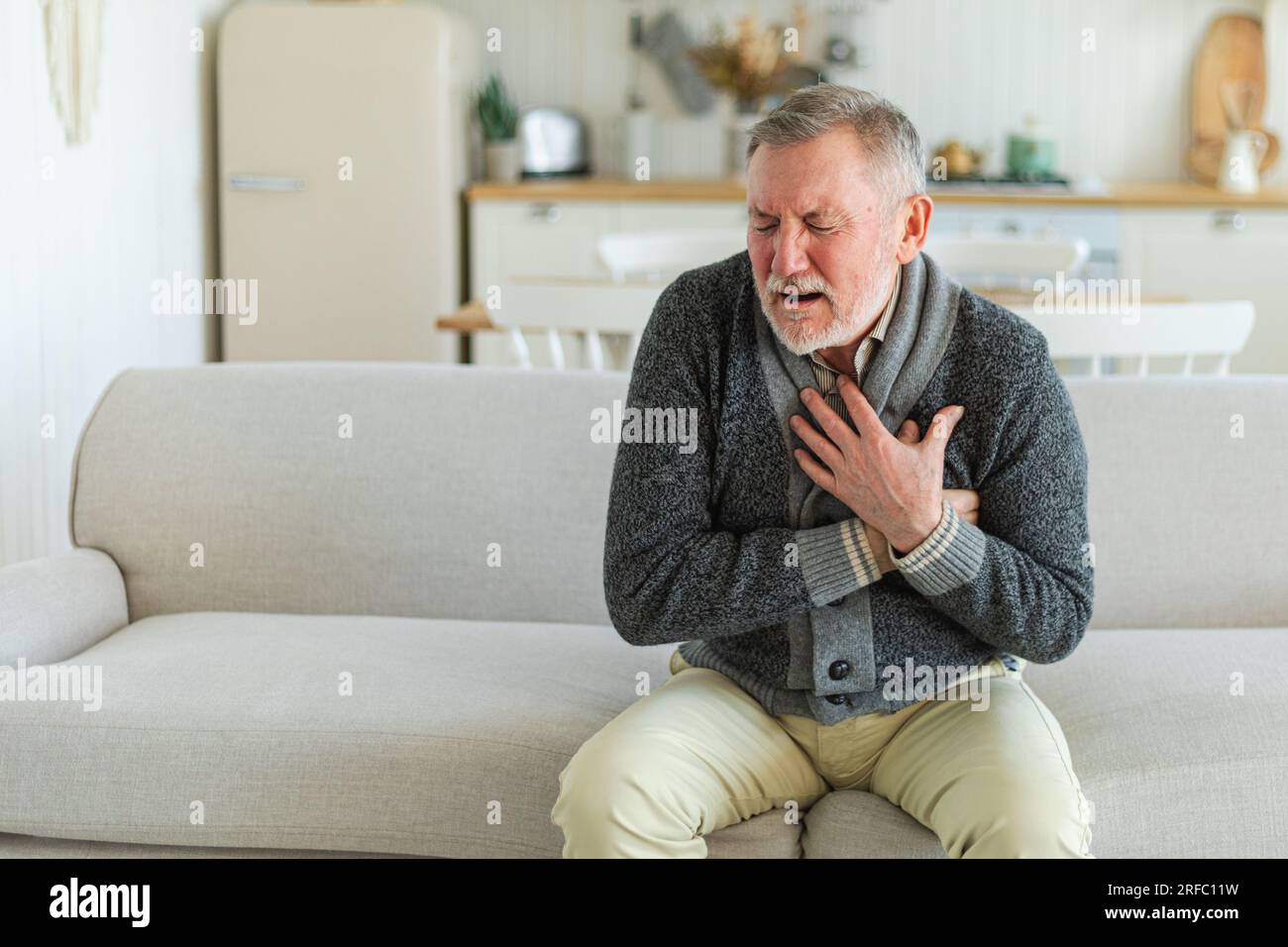 Pain on heart, heart attack. Unhappy middle aged senior man suffering ...