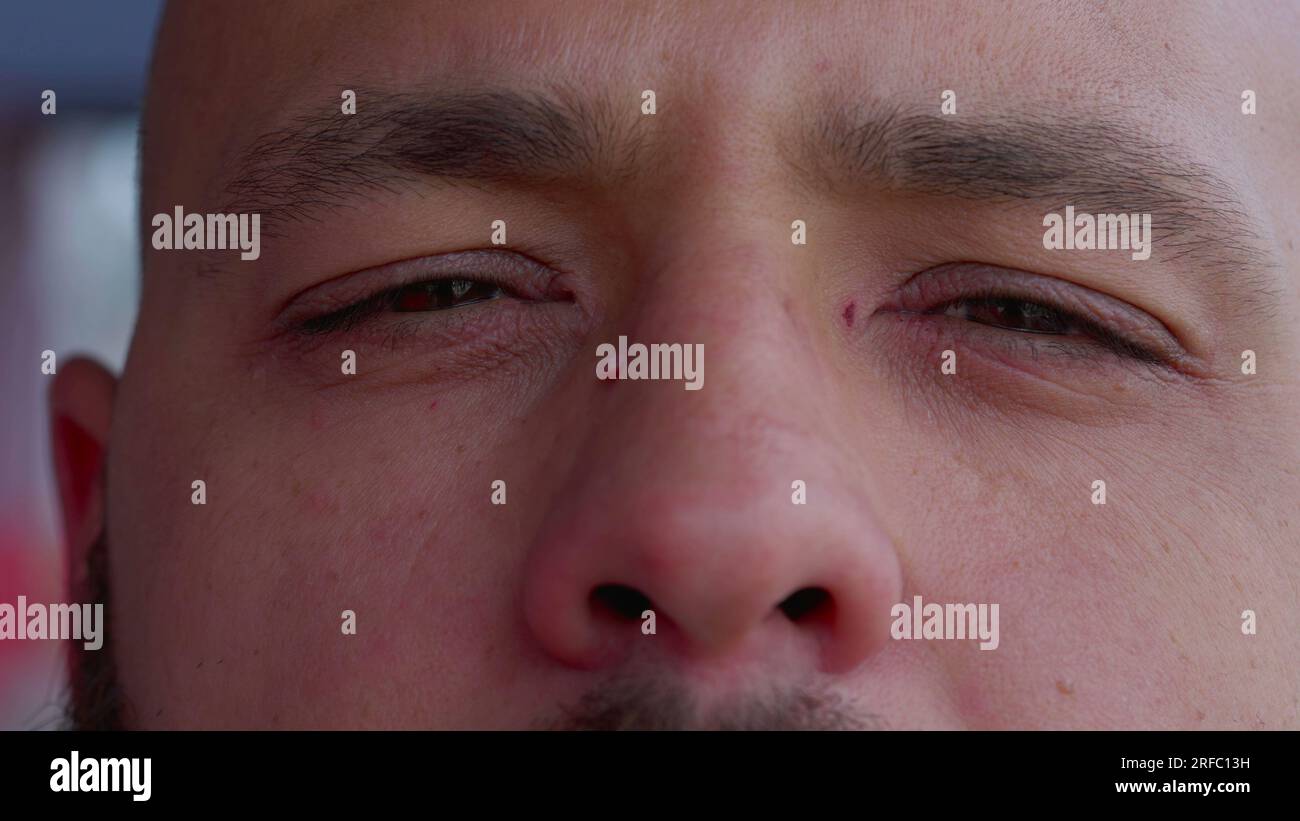 Macro close-up of a man face with judgemental expression. Serious upset ...